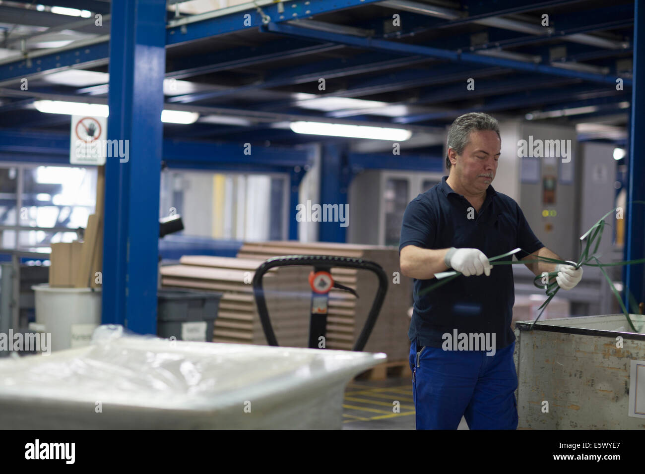 Senior man working in factory Stock Photo - Alamy