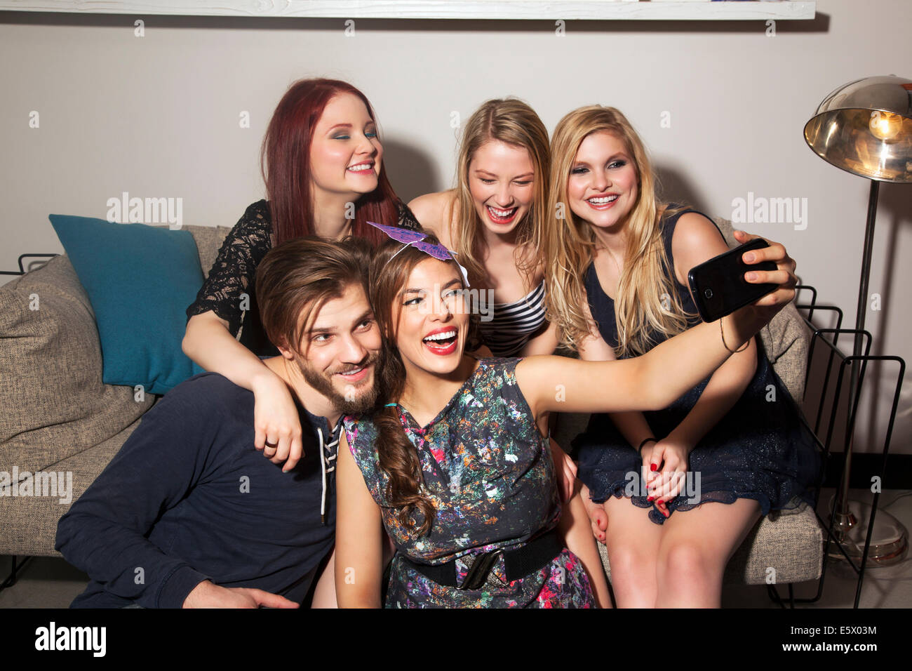 Friends taking selfie on sofa Stock Photo - Alamy