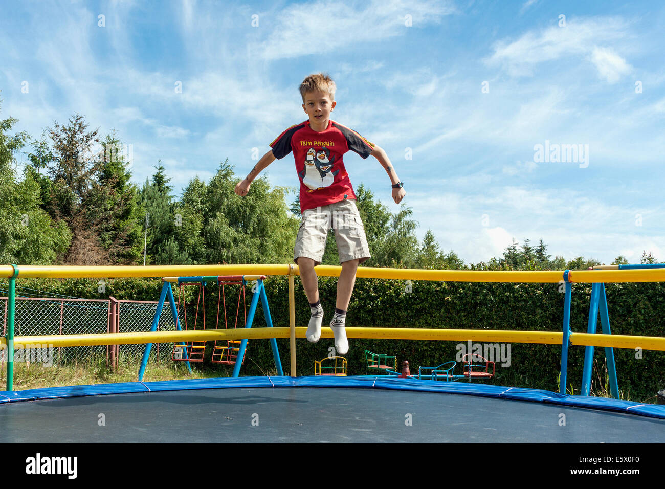 Happy boy jumping on a trampoline Stock Photo - Alamy