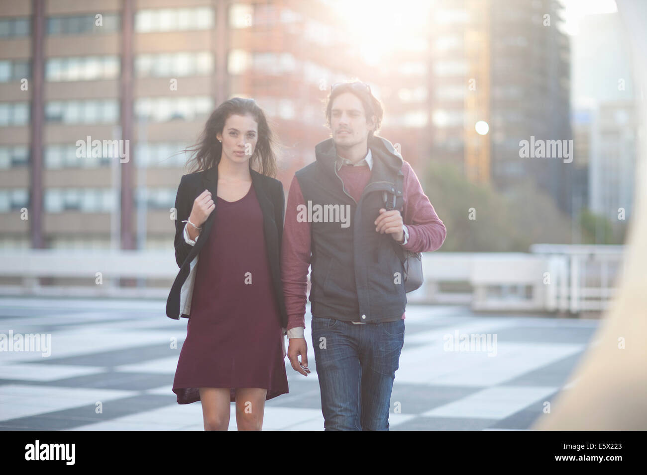 Couple walking across rooftop parking lot in city Stock Photo - Alamy