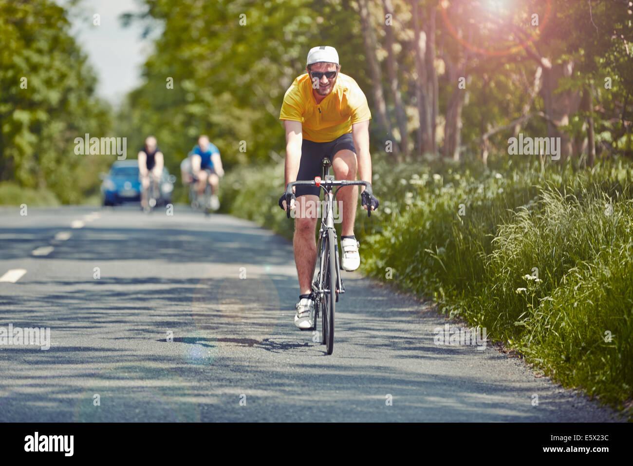 Cyclists riding on single carriageway, Cotswolds, UK Stock Photo - Alamy