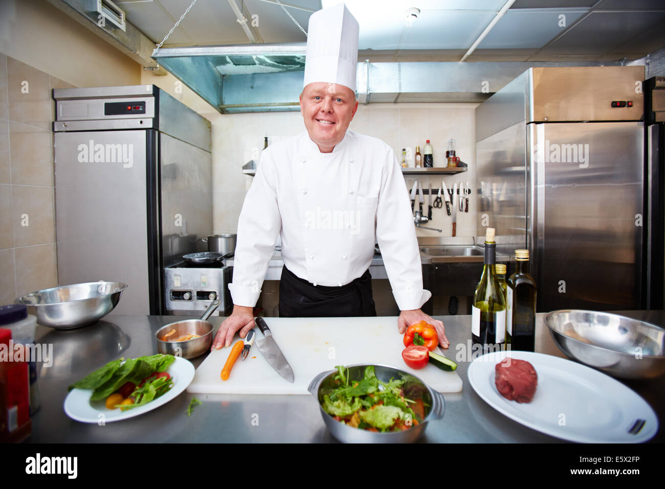 Image of male chef looking at camera in the kitchen Stock Photo - Alamy