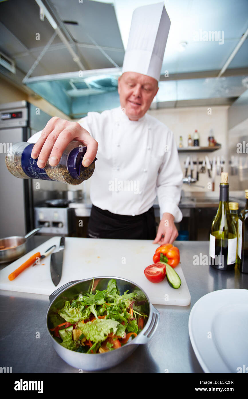 Image of male chef preparing vegetable salad in the kitchen Stock Photo ...