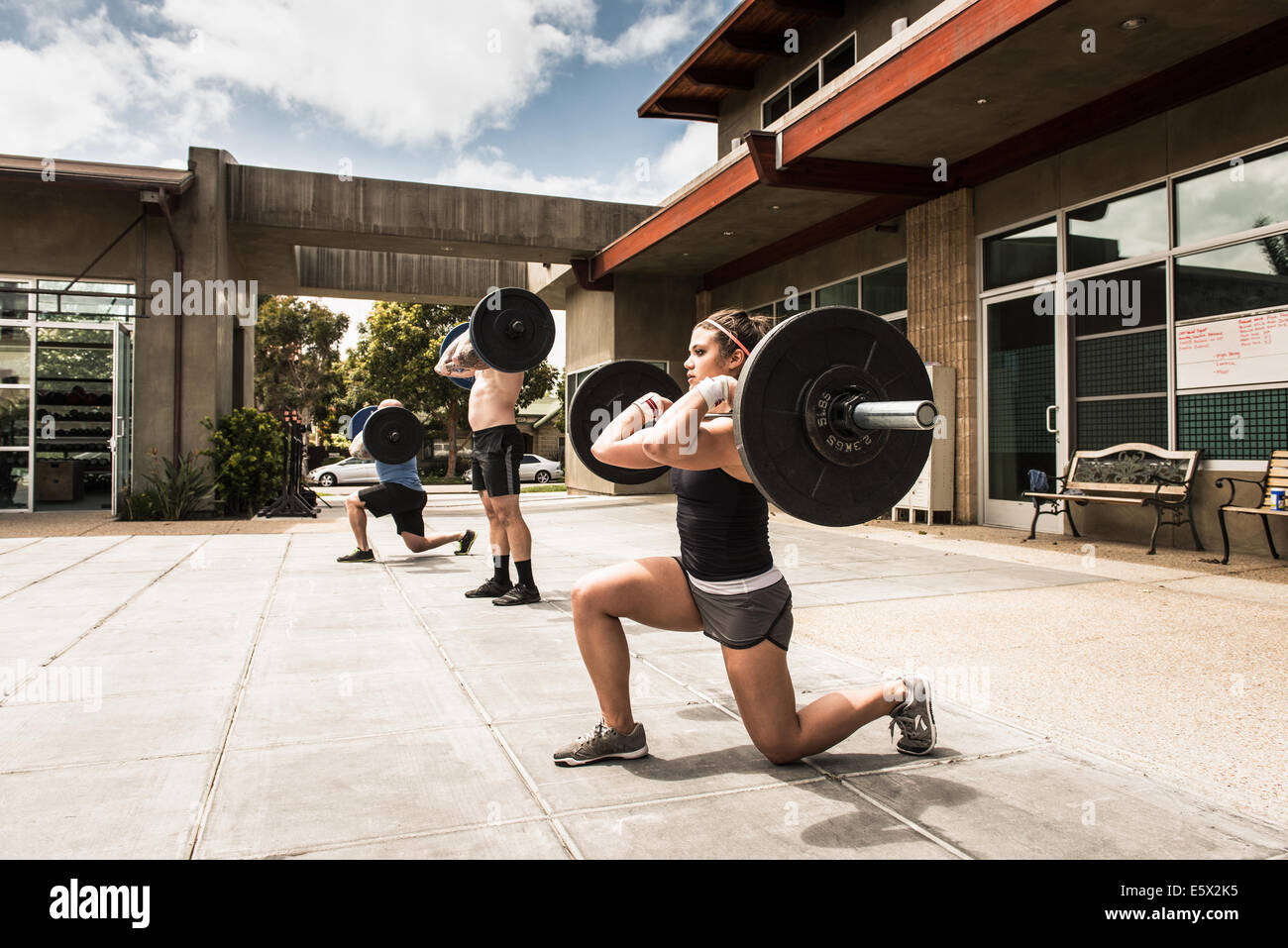 Bodybuilders lifting barbell outdoors Stock Photo - Alamy