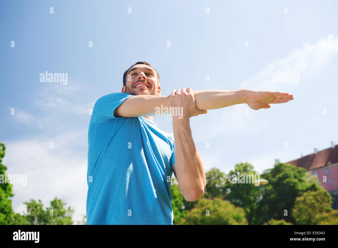 smiling man stretching outdoors Stock Photo - Alamy