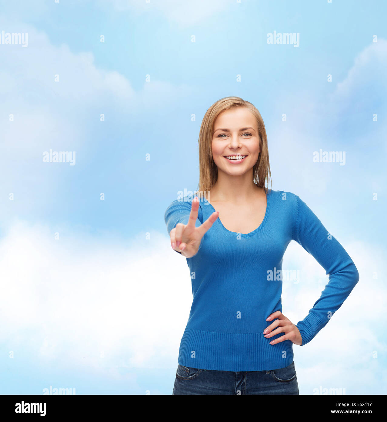 smiling teenage girl showing v-sign with hand Stock Photo - Alamy