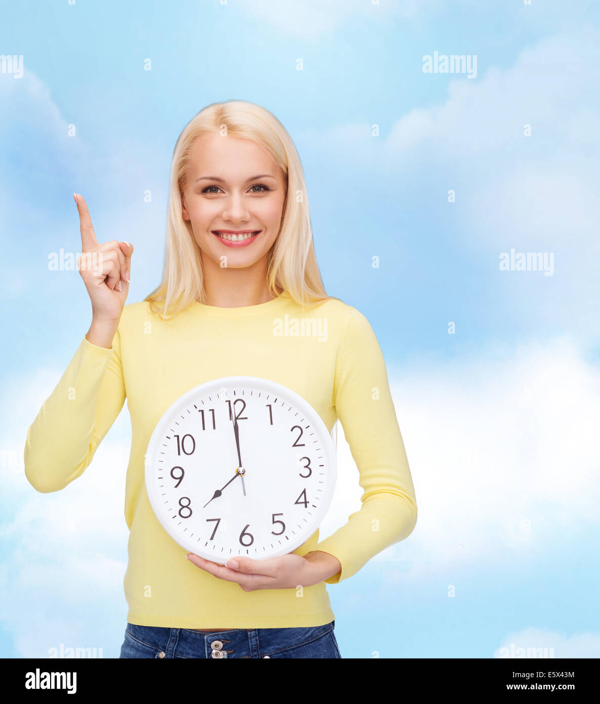 student with wall clock and finger up Stock Photo - Alamy