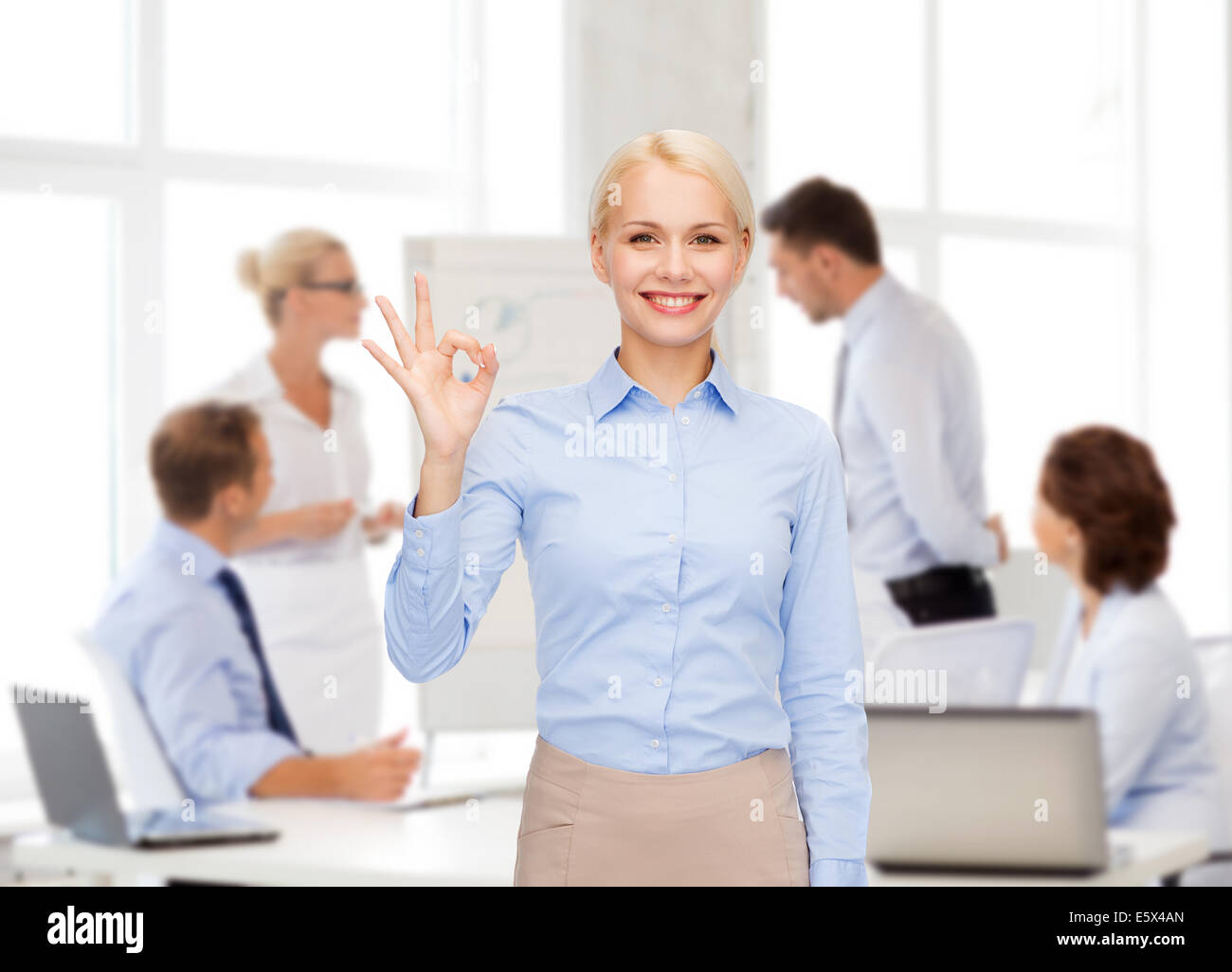 smiling businesswoman showing ok-sign with hand Stock Photo - Alamy