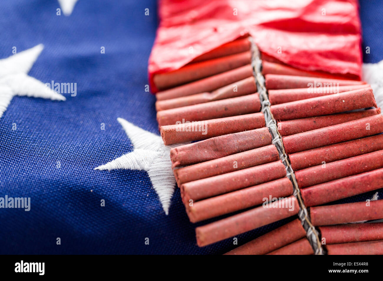 Roll of firecrackers with folded American flag Stock Photo - Alamy