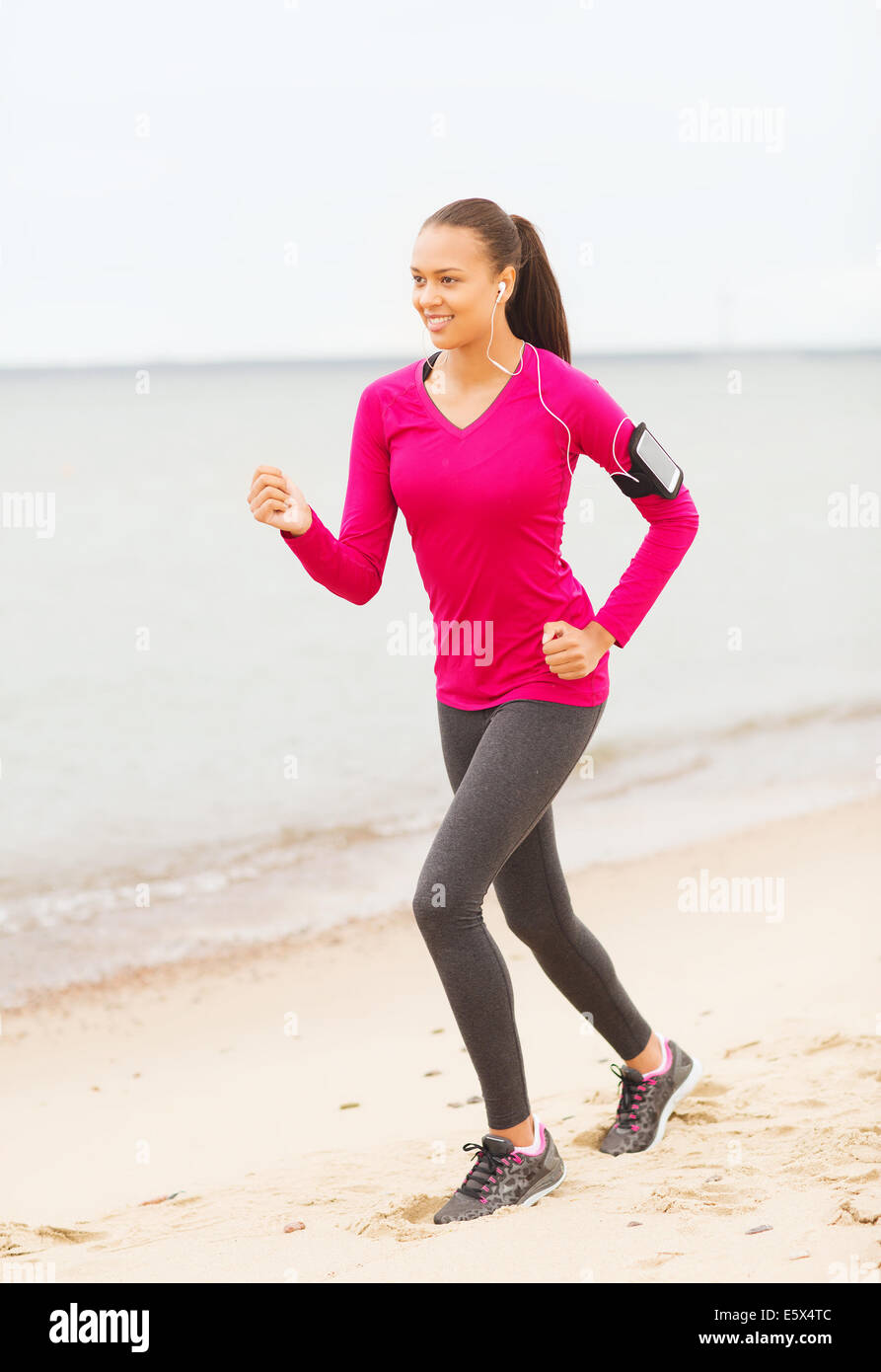 smiling woman running on track outdoors Stock Photo - Alamy