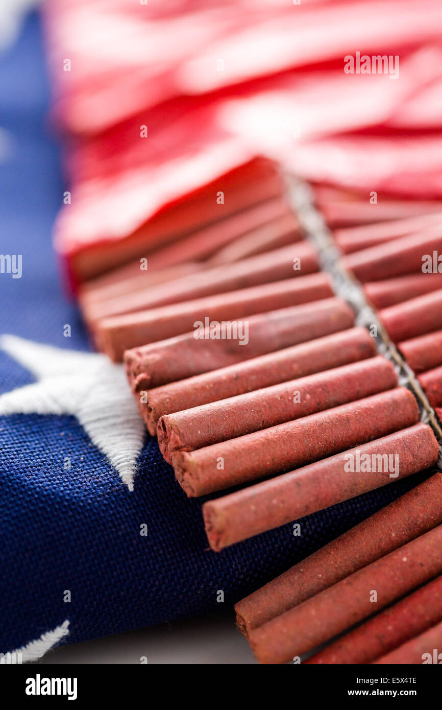 Roll of firecrackers with folded American flag Stock Photo - Alamy