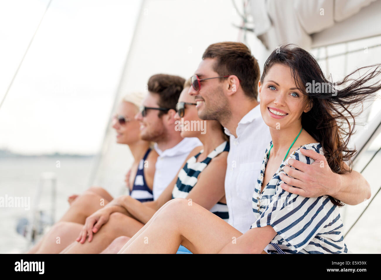 smiling friends sitting on yacht deck Stock Photo - Alamy
