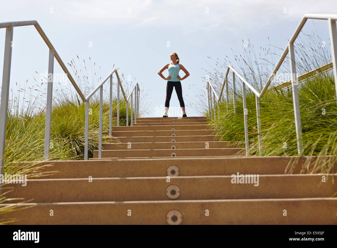 Woman standing at top of stairs Stock Photo - Alamy
