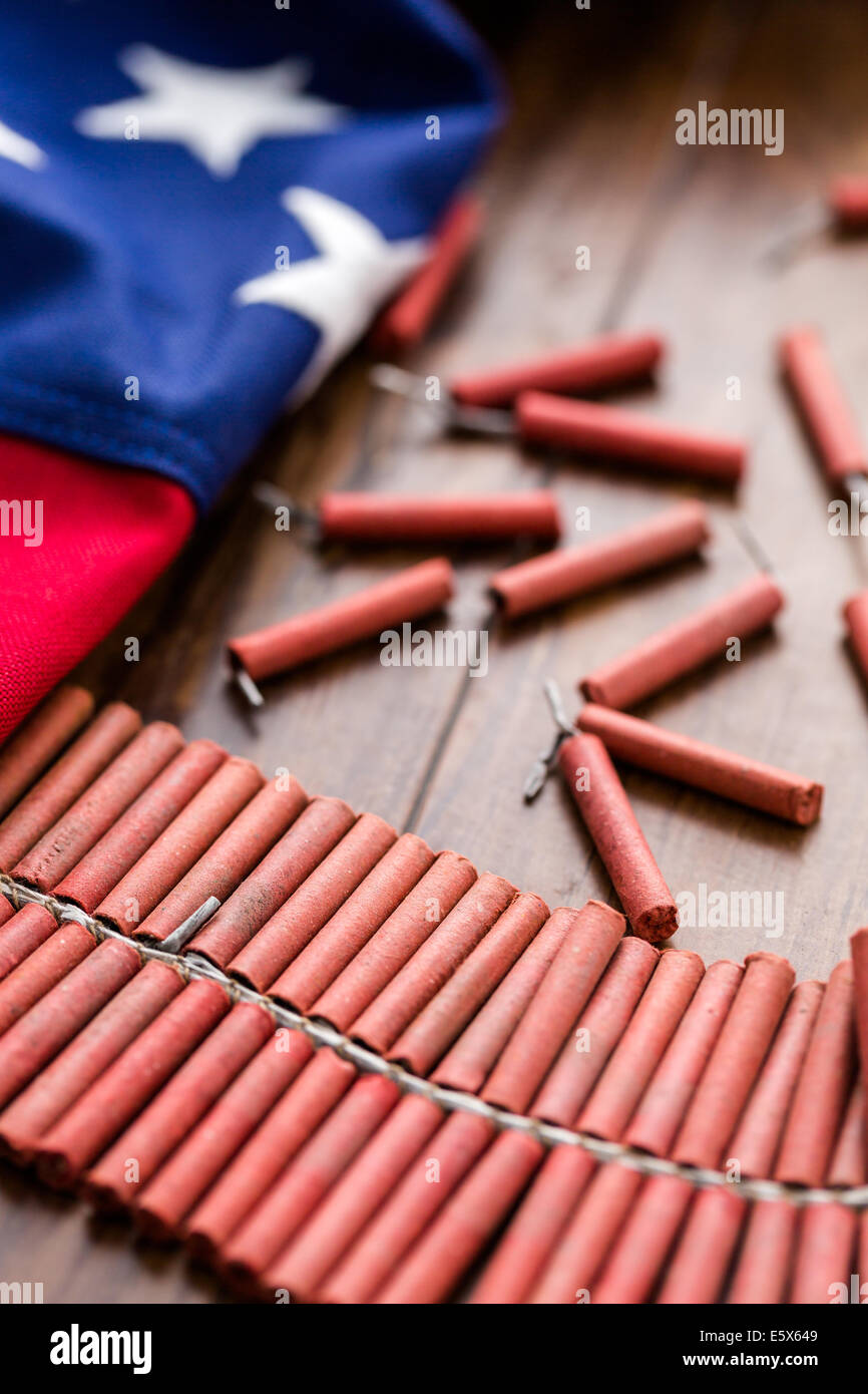 Roll of firecrackers with folded American flag Stock Photo - Alamy