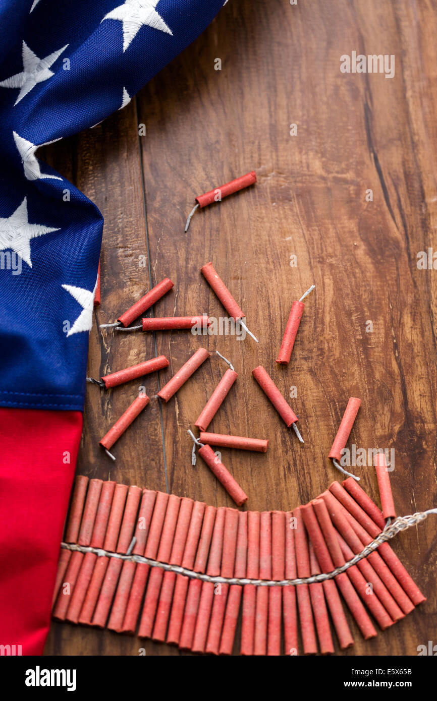 Roll of firecrackers with folded American flag Stock Photo - Alamy