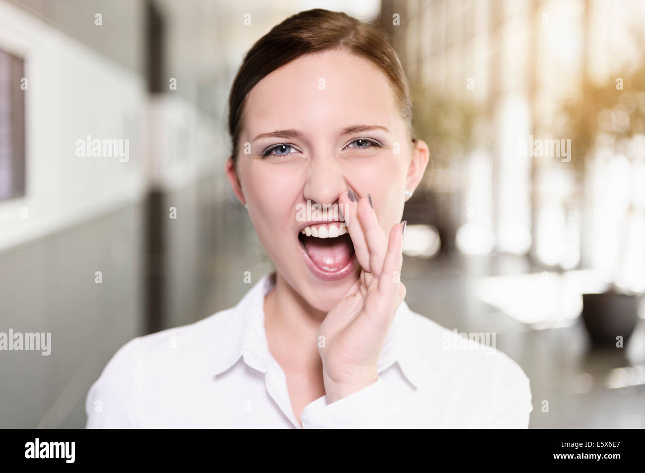 Portrait of young businesswoman shouting in office Stock Photo - Alamy