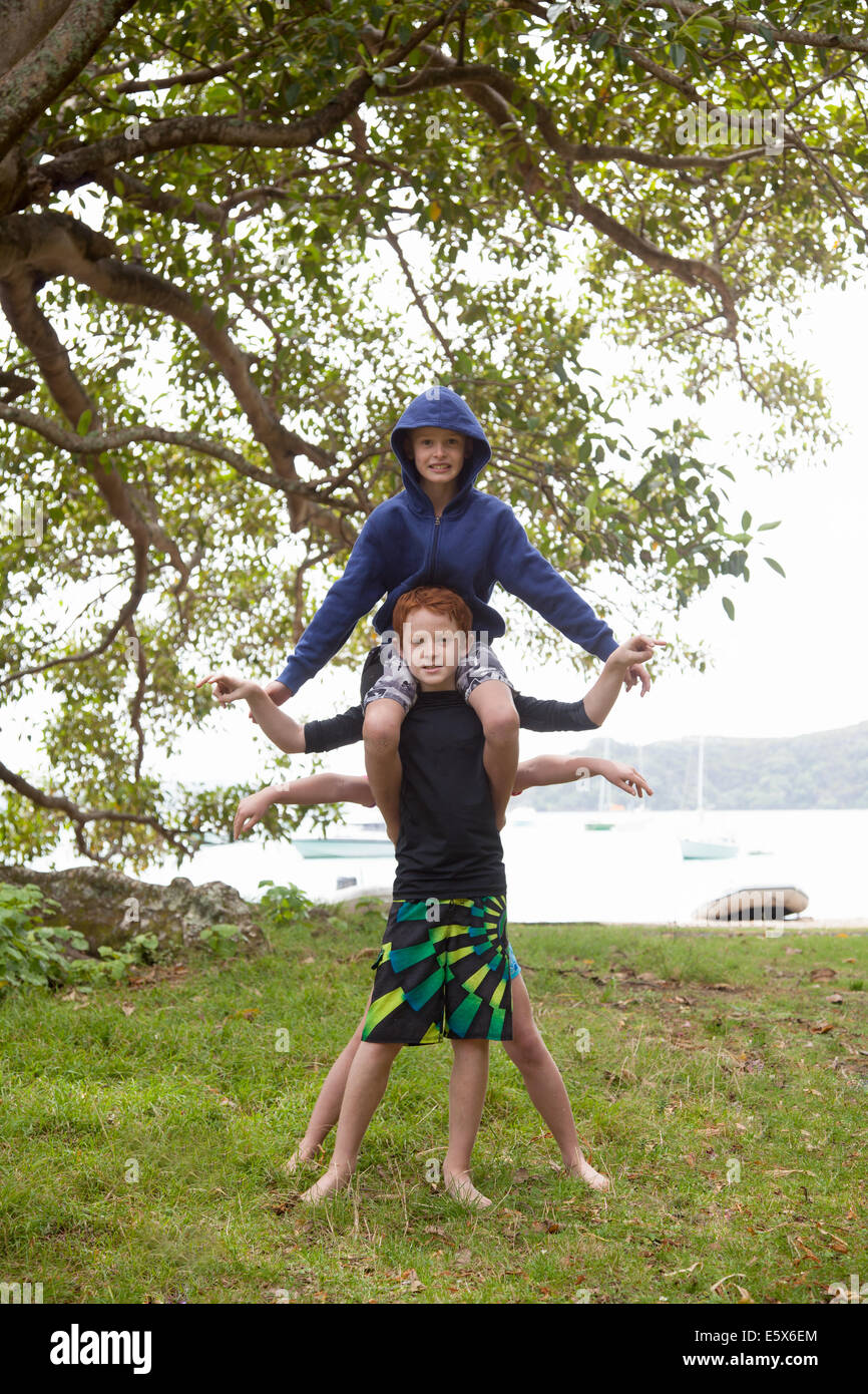 Portrait of three boys, one behind and another on shoulders Stock Photo ...