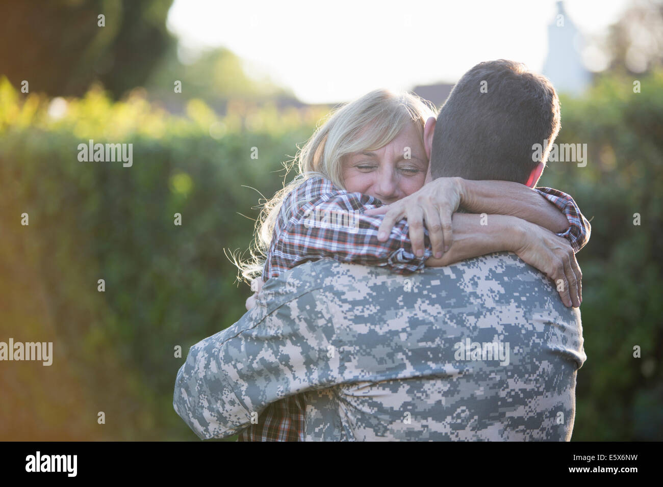 Male soldier hugging mother on street at homecoming Stock Photo - Alamy