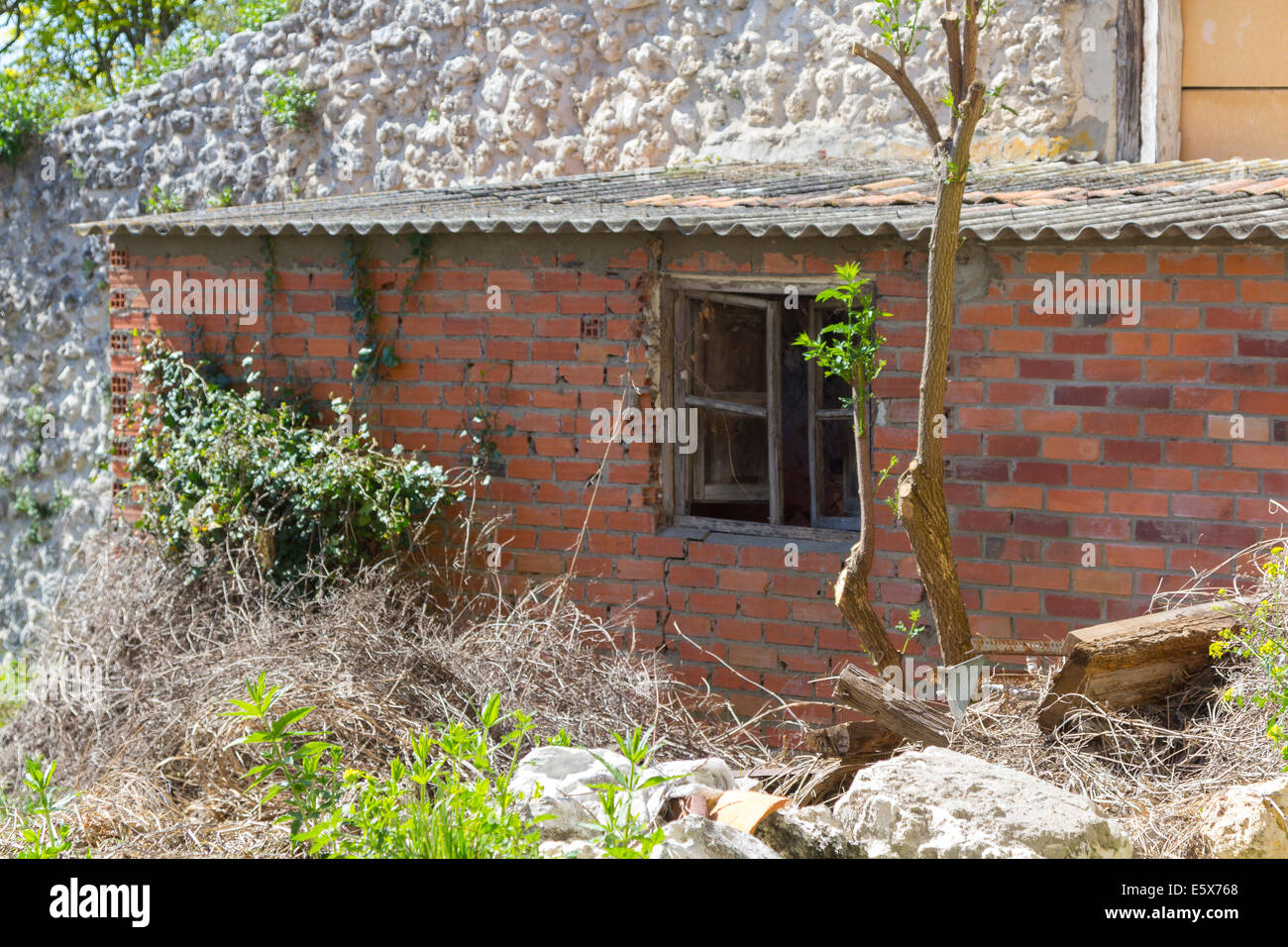 Small House abandoned bricks and broken window Stock Photo - Alamy