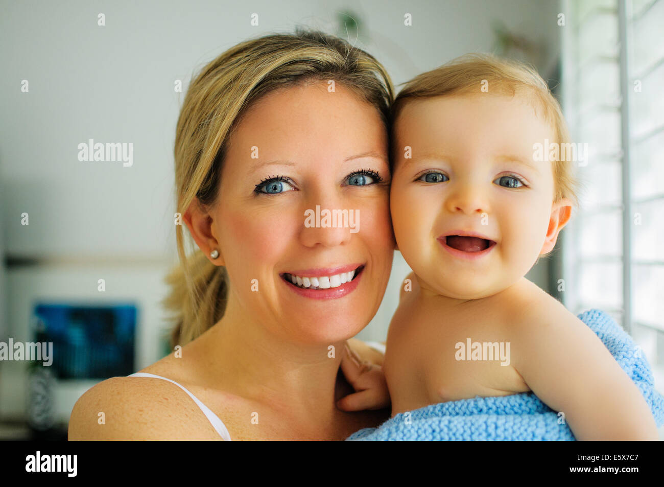 Portrait of mid adult mother and baby girl smiling Stock Photo - Alamy