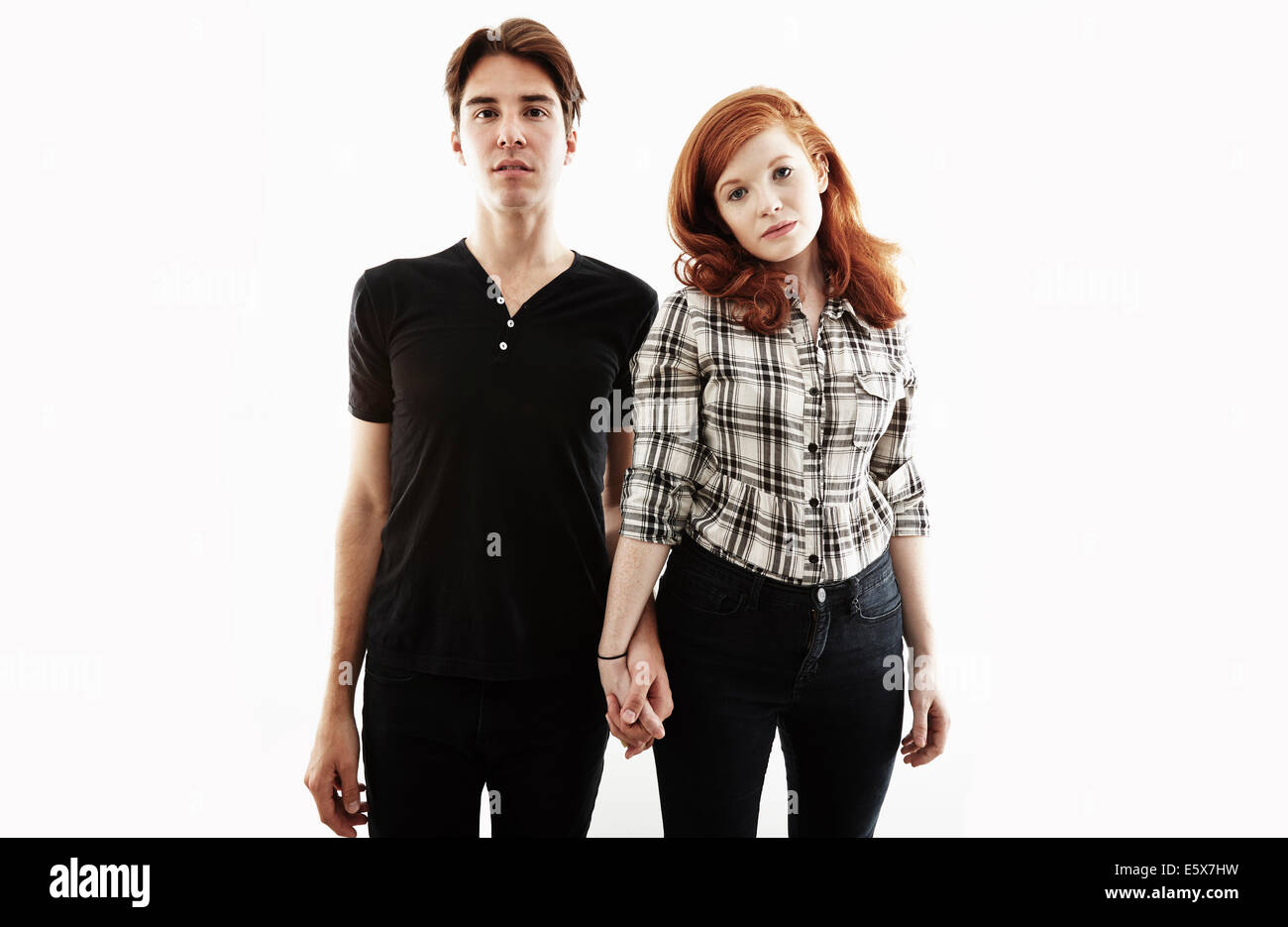 Studio portrait of bored looking young couple Stock Photo - Alamy