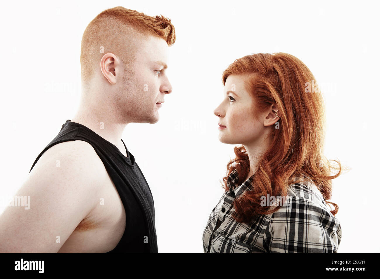 Studio portrait of red haired young couple gazing face to face Stock ...