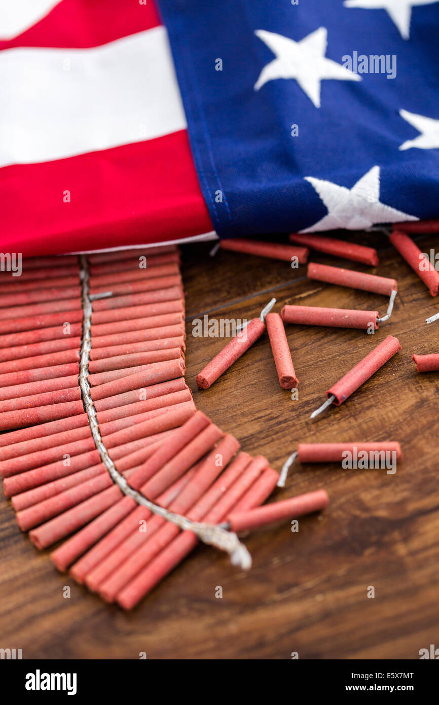 Roll of firecrackers with folded American flag Stock Photo - Alamy