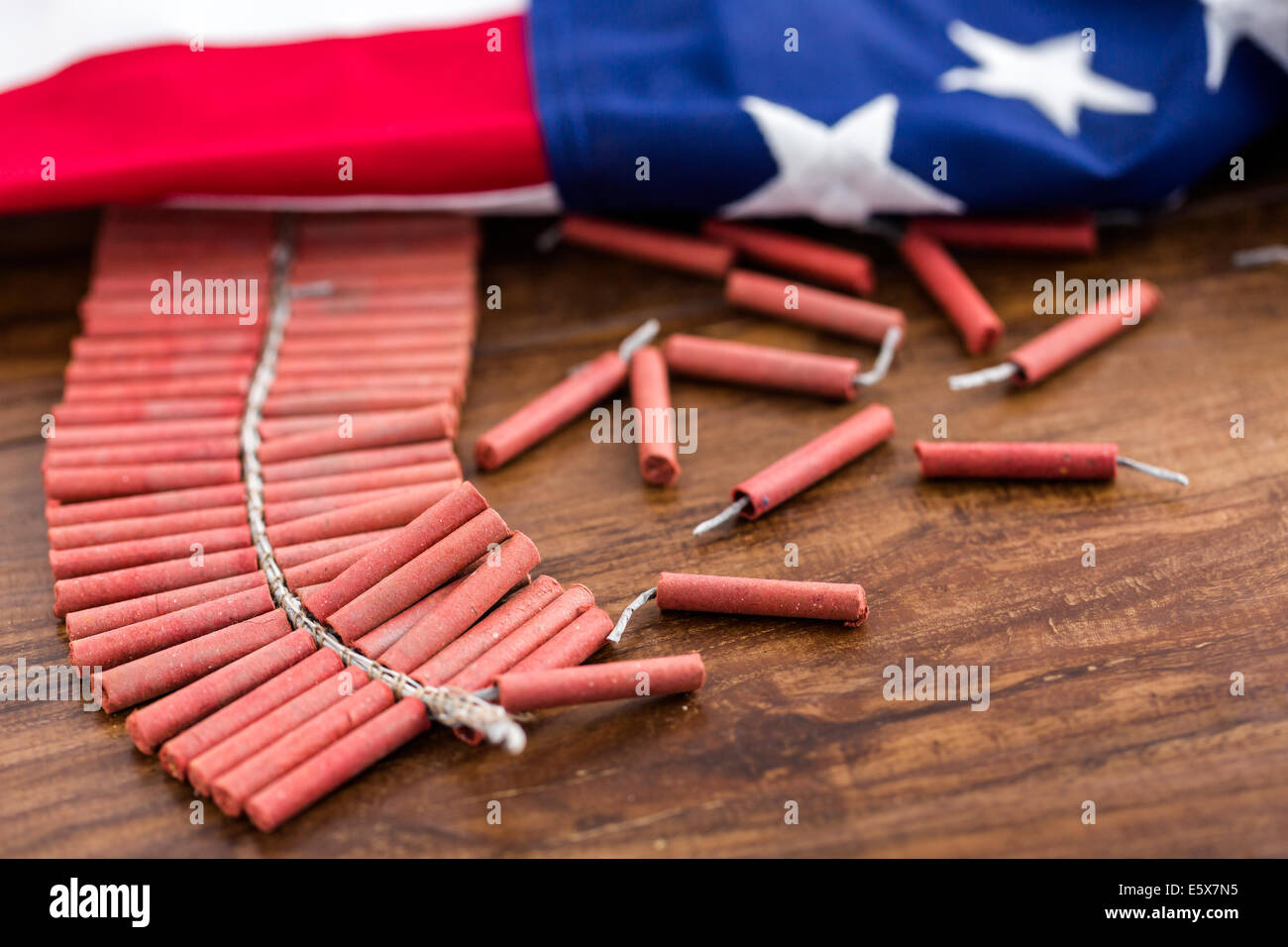 Roll of firecrackers with folded American flag Stock Photo - Alamy