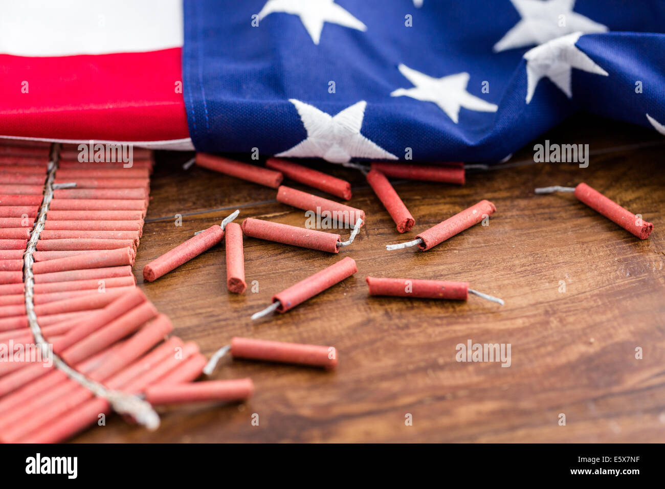 Roll of firecrackers with folded American flag Stock Photo - Alamy
