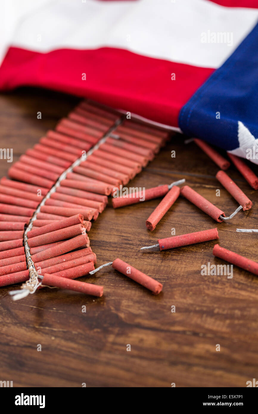 Roll of firecrackers with folded American flag Stock Photo - Alamy
