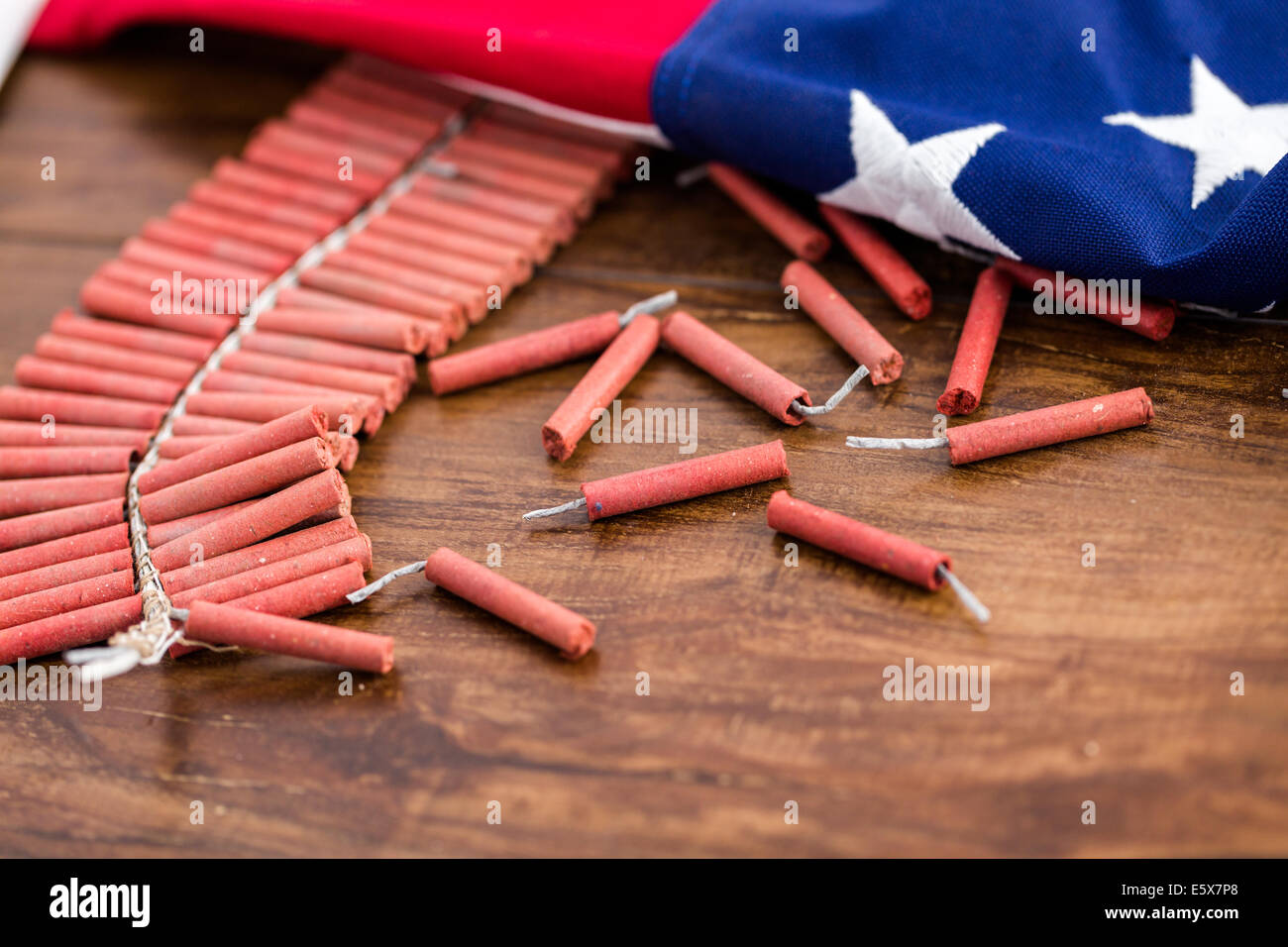 Roll of firecrackers with folded American flag Stock Photo - Alamy