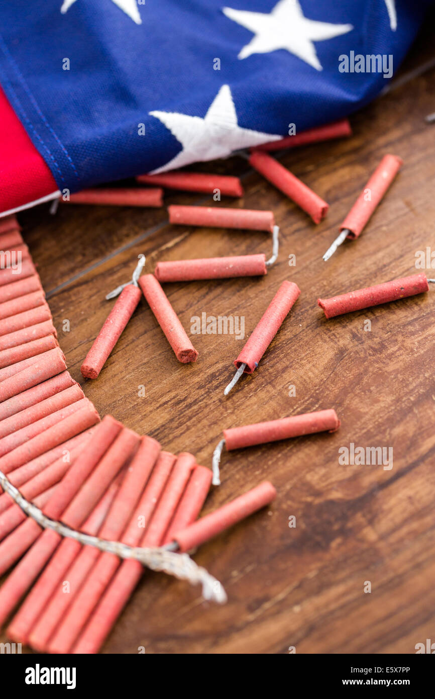Roll of firecrackers with folded American flag Stock Photo - Alamy