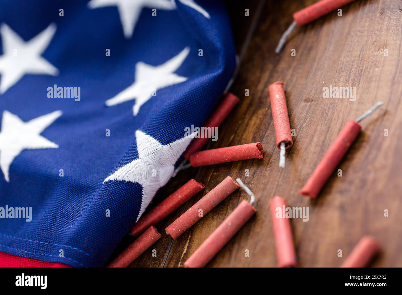 Roll of firecrackers with folded American flag Stock Photo - Alamy