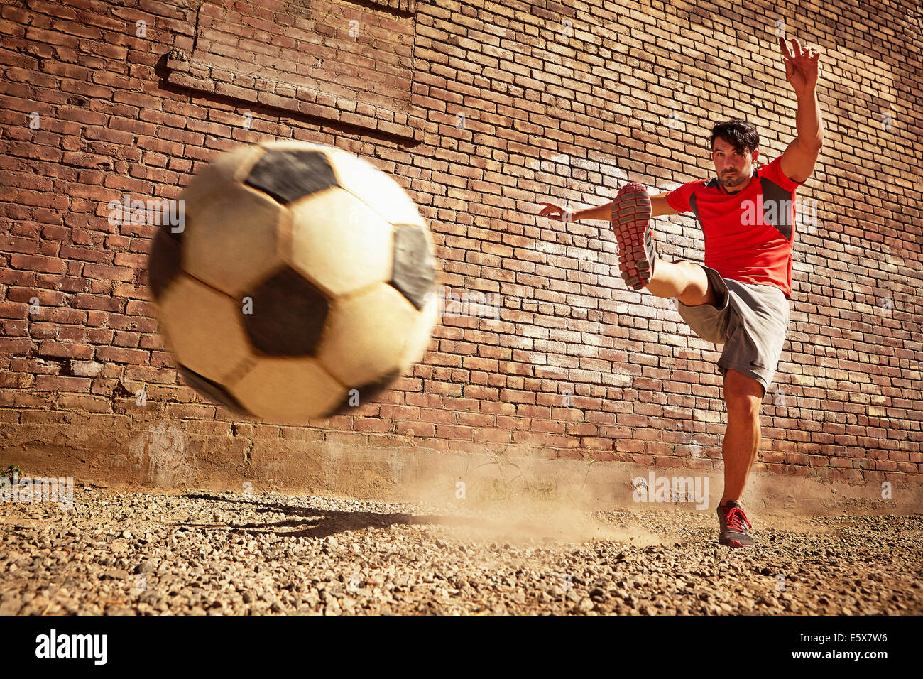 Man kicking ball hi-res stock photography and images - Alamy