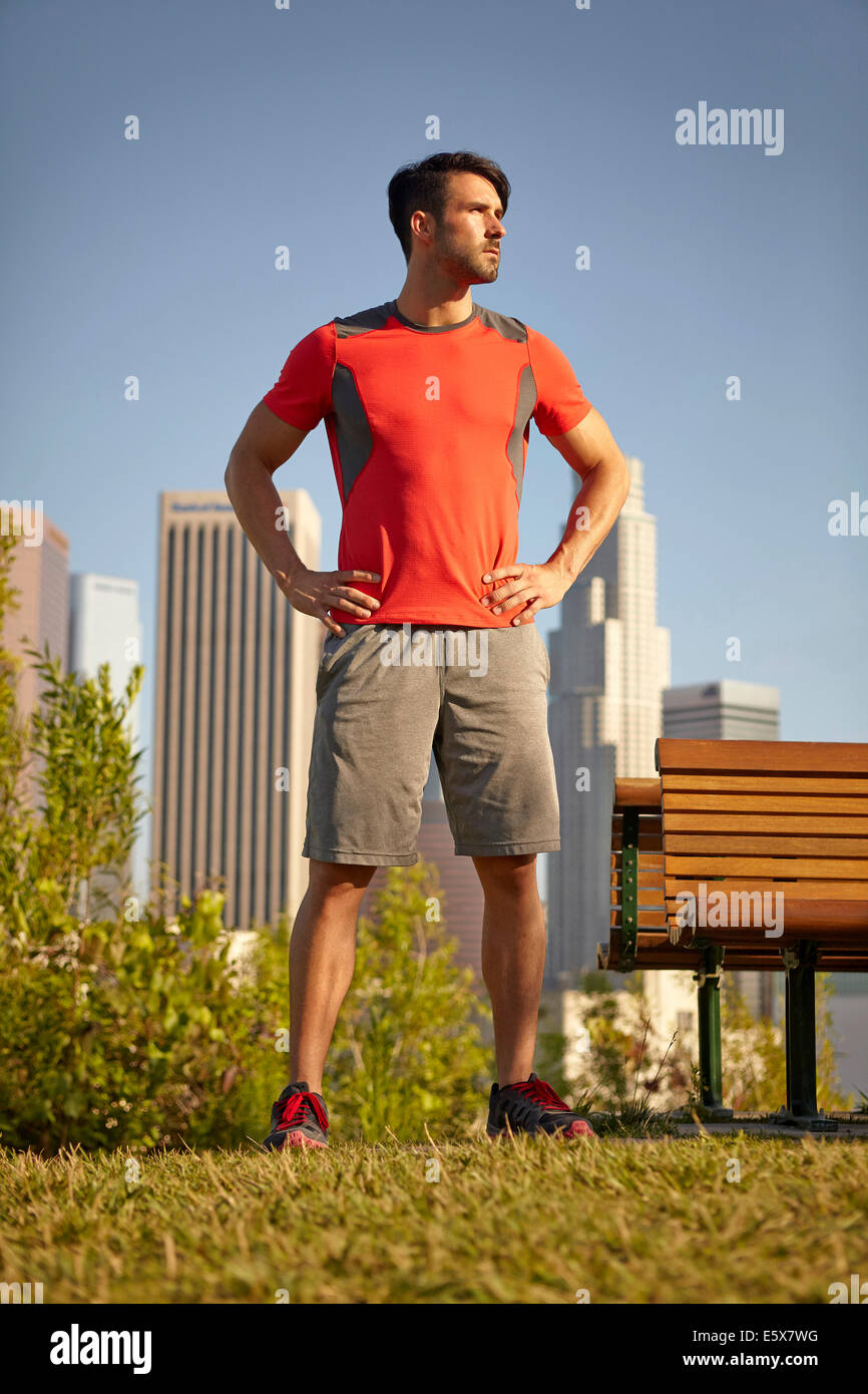 Young male runner taking a break in park Stock Photo - Alamy