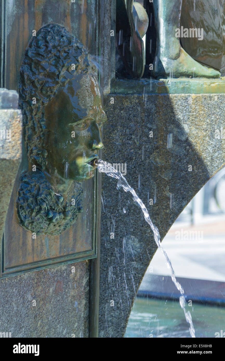 Old bronze fountain with the face of a woman Stock Photo - Alamy