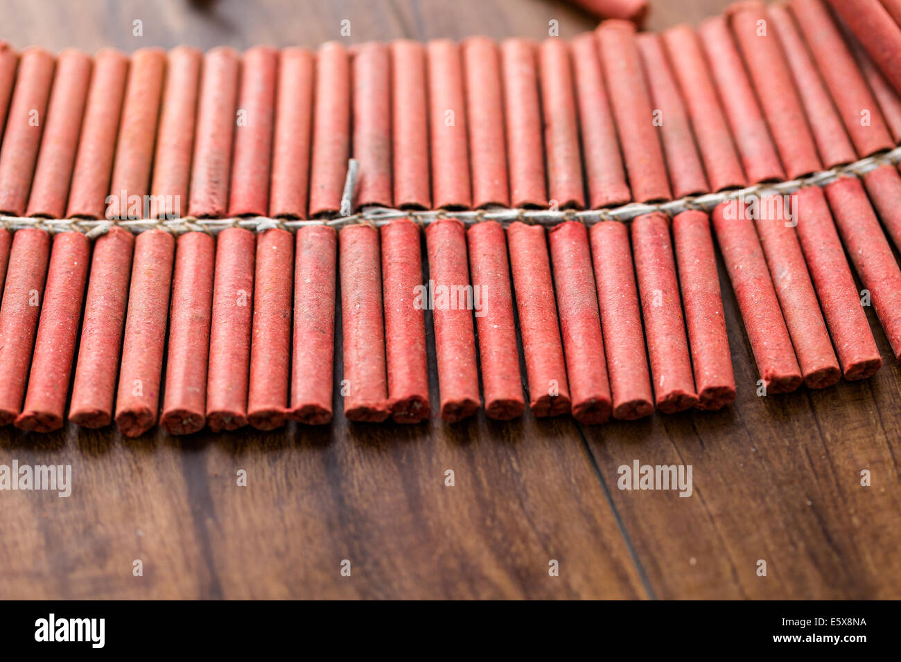 Roll of firecrackers on wood table Stock Photo - Alamy