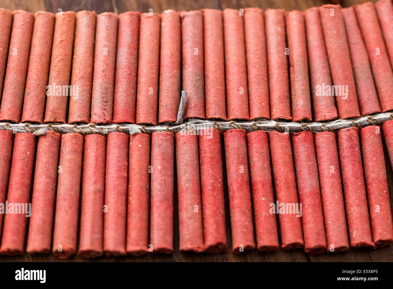 Roll of firecrackers on wood table Stock Photo - Alamy