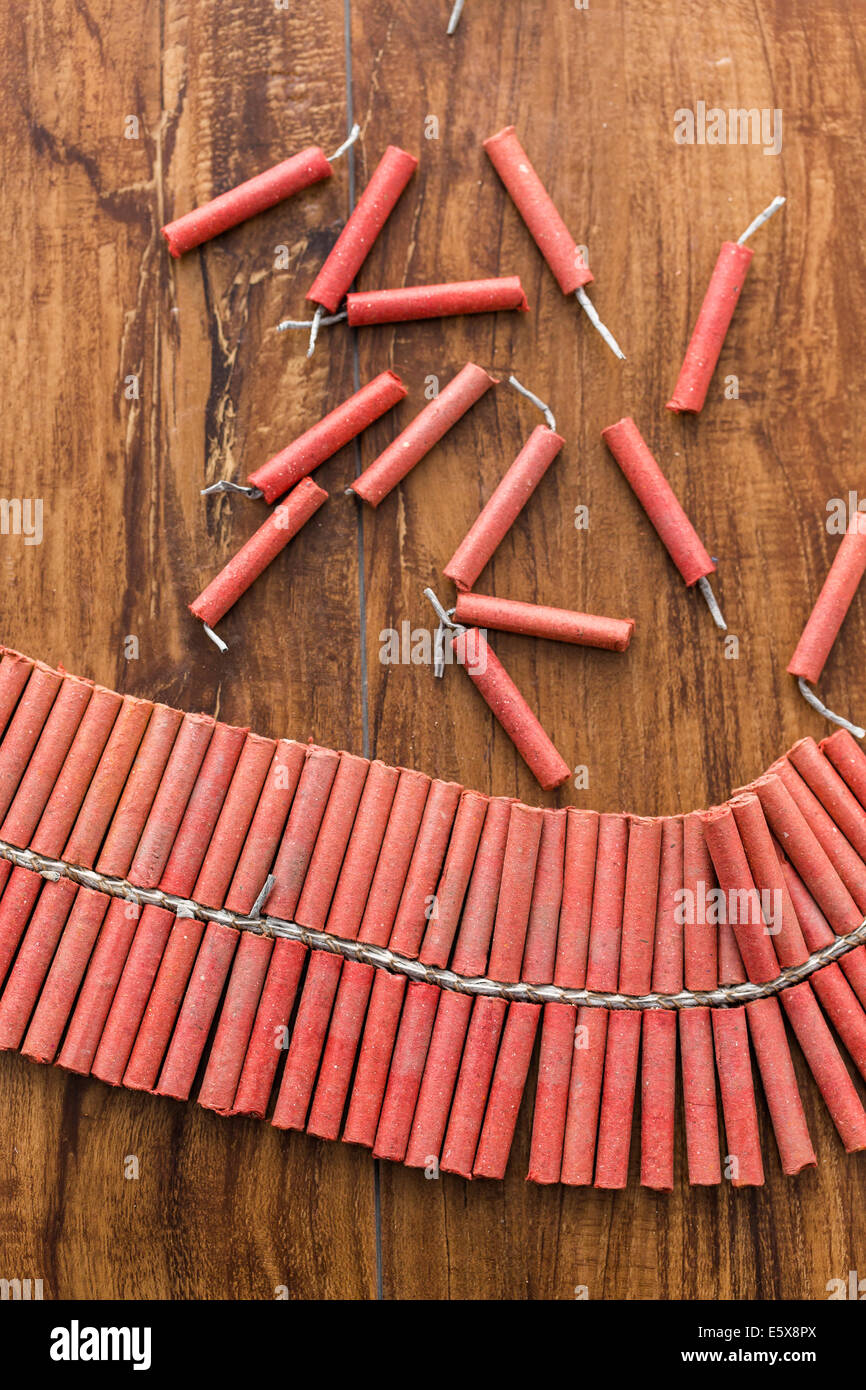 Roll of firecrackers on wood table Stock Photo - Alamy