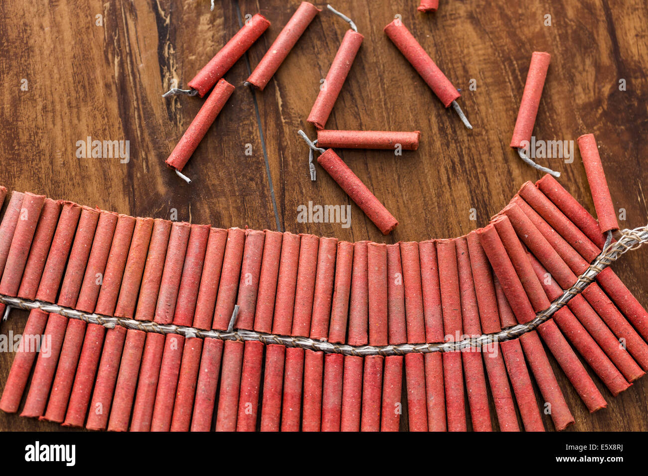 Roll of firecrackers on wood table Stock Photo - Alamy