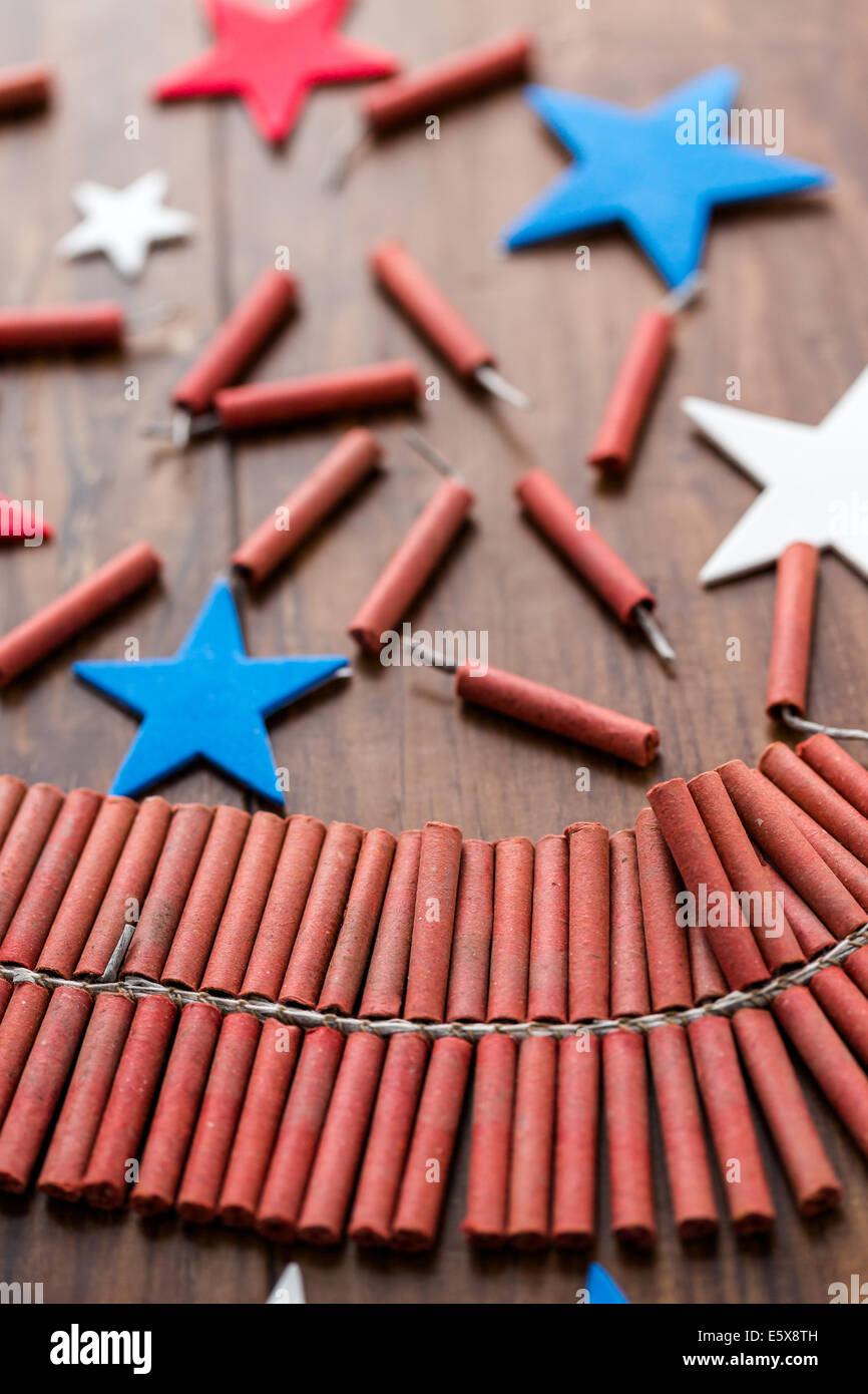 Roll of firecrackers with red, white and blue stars on wood table Stock ...