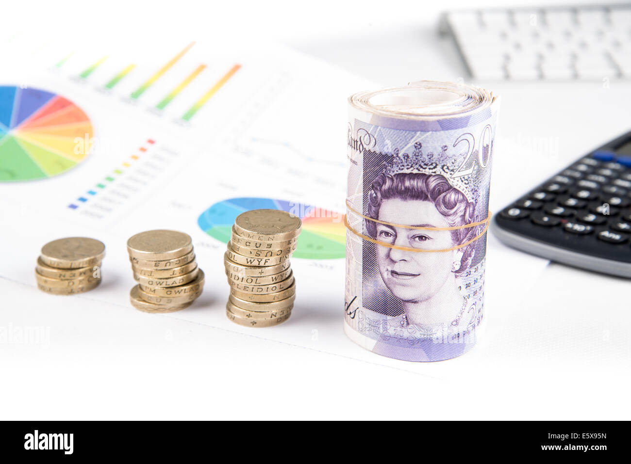 British pound coins and notes with financial chart Stock Photo - Alamy