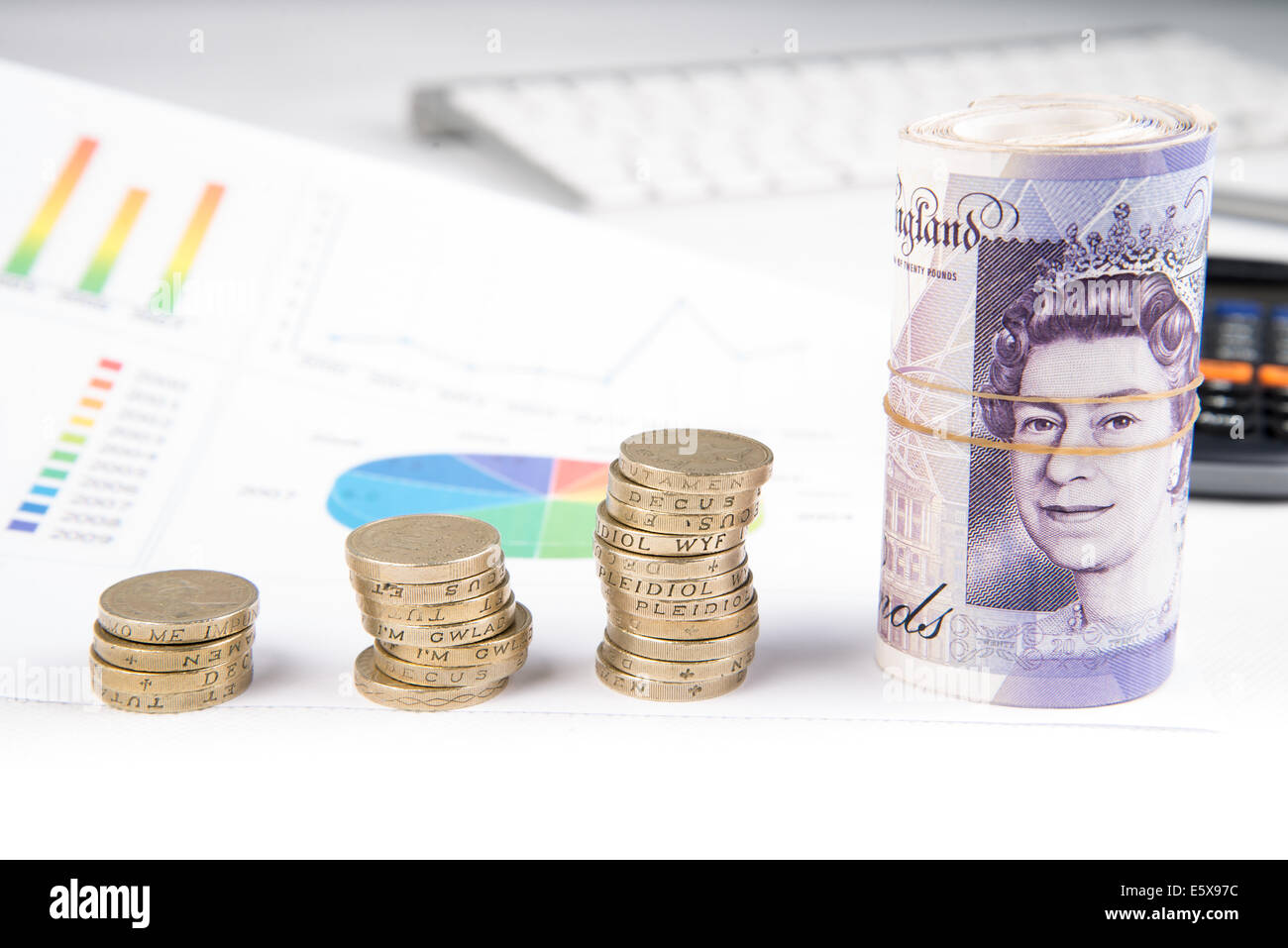 British pound coins and notes with financial chart Stock Photo - Alamy