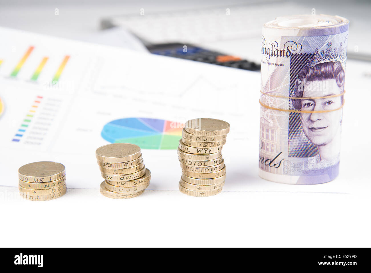 British pound coins and notes with financial chart Stock Photo - Alamy