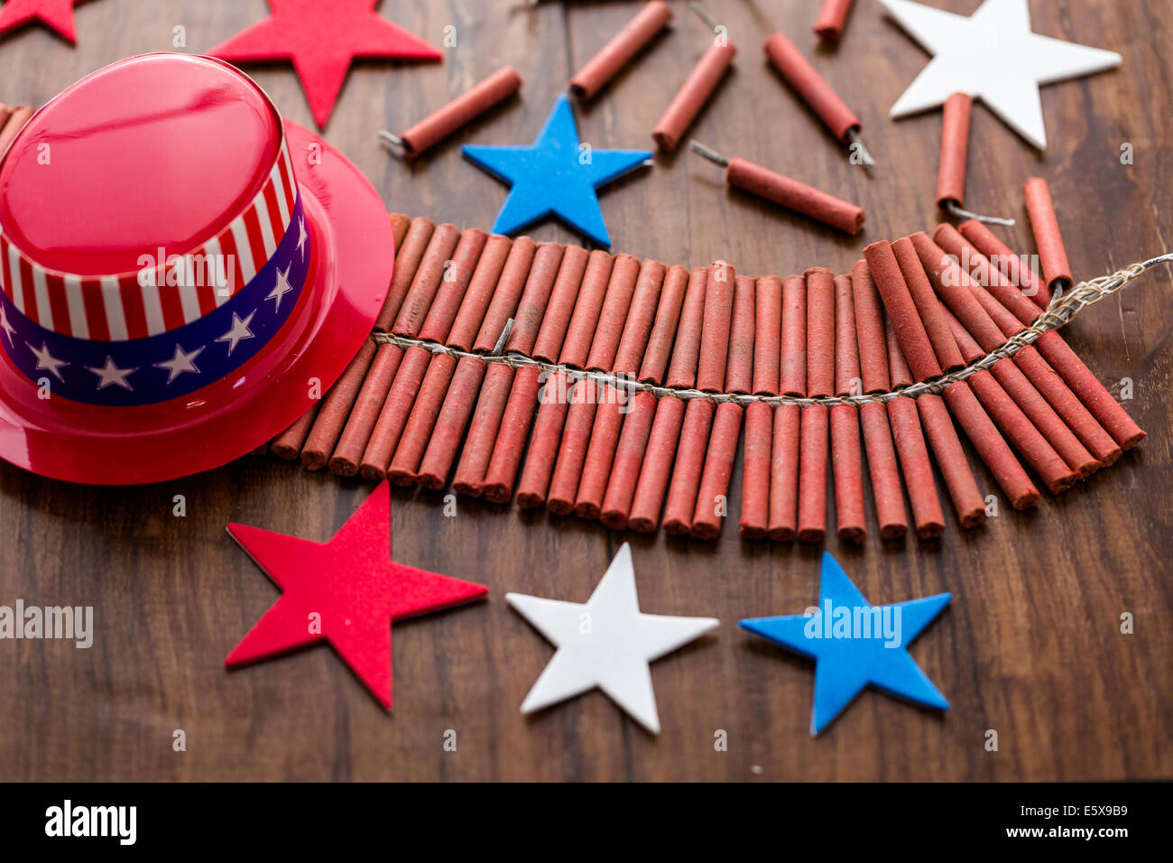 Roll of firecrackers with red, white and blue stars on wood table Stock ...