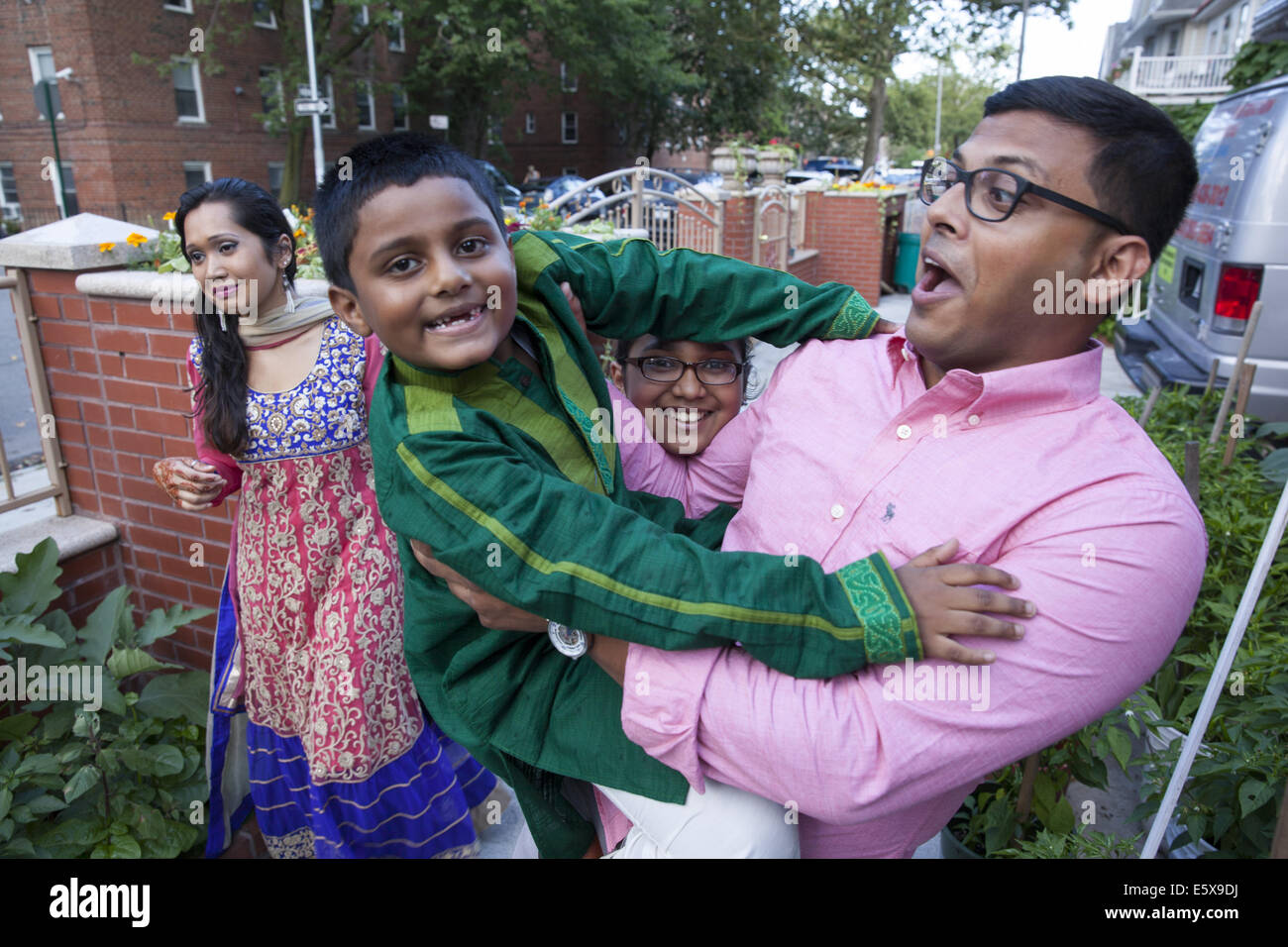 Uncle has fun with his nephew at a family gathering of Bangladeshi ...