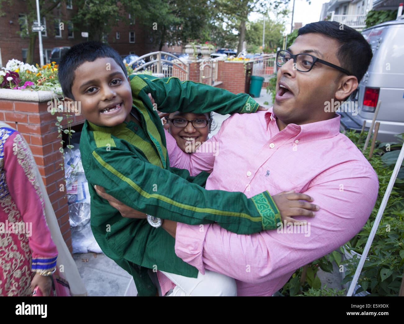Uncle has fun with his nephew at a family gathering of Bangladeshi ...