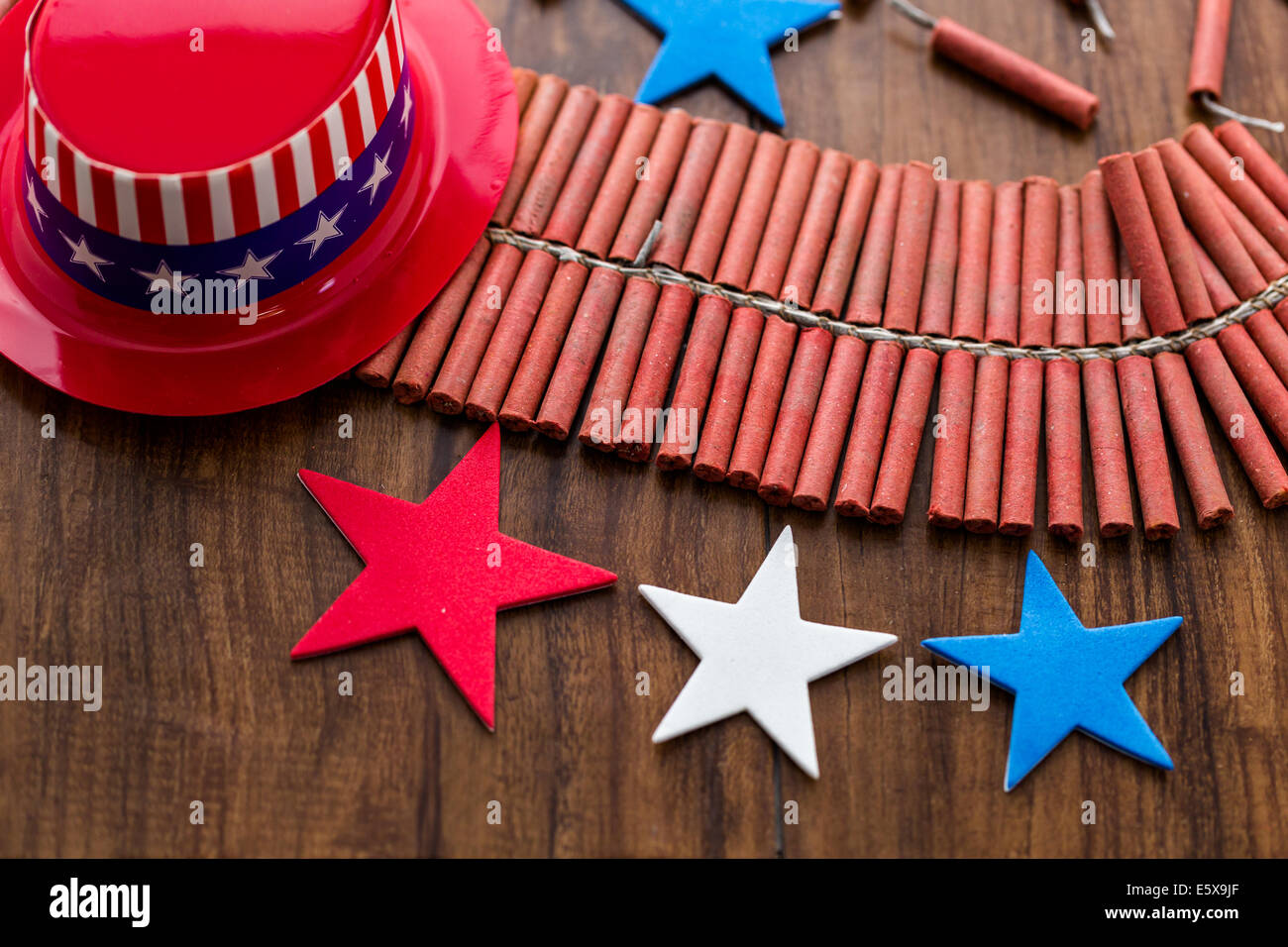 Roll of firecrackers with red, white and blue stars on wood table Stock ...