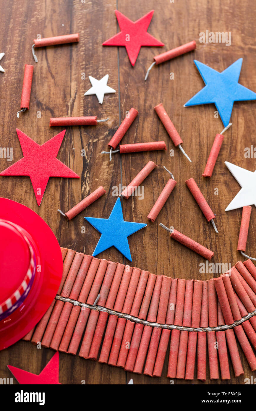 Roll of firecrackers with red, white and blue stars on wood table Stock ...