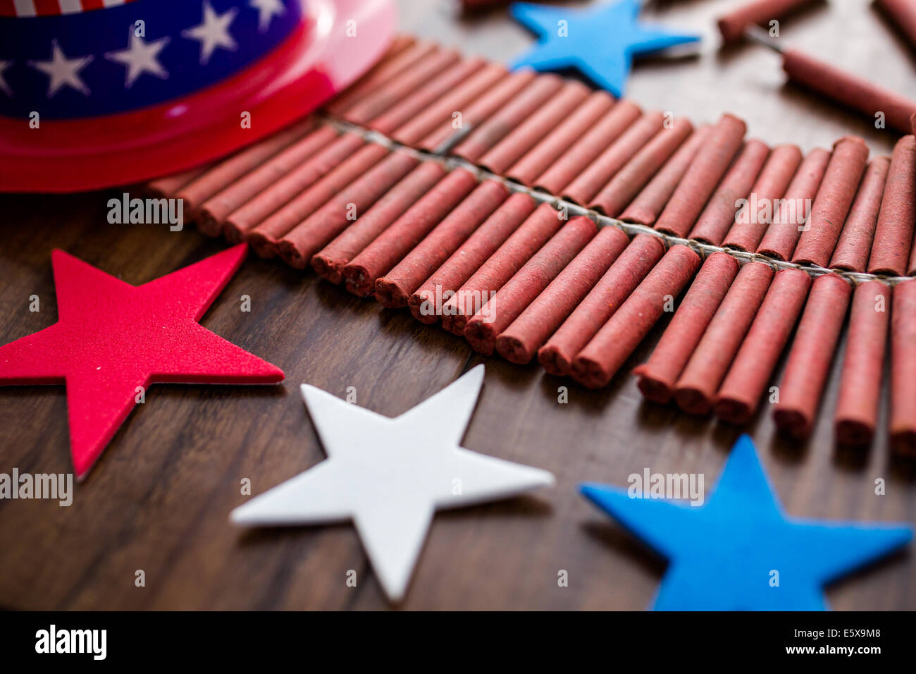 Roll of firecrackers with red, white and blue stars on wood table Stock ...